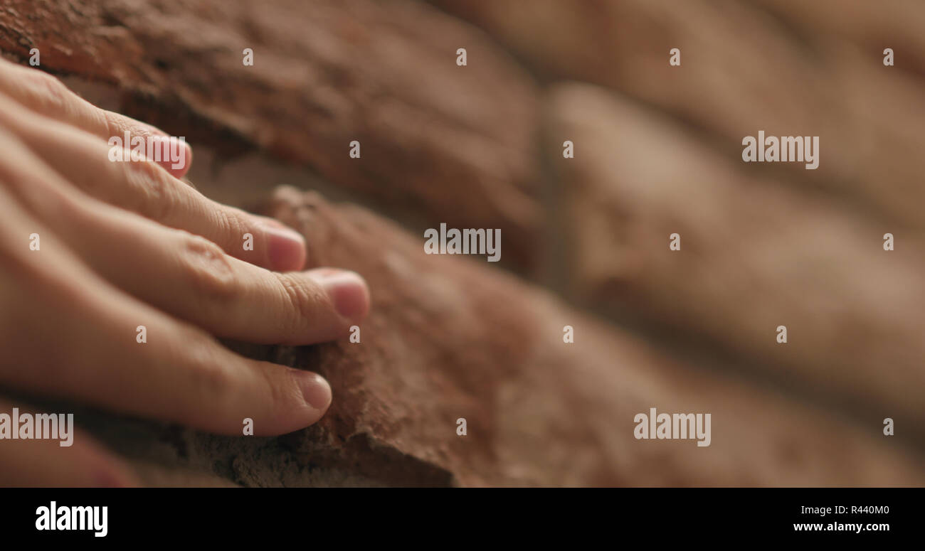 closeup man hand touching old brick wall Stock Photo - Alamy