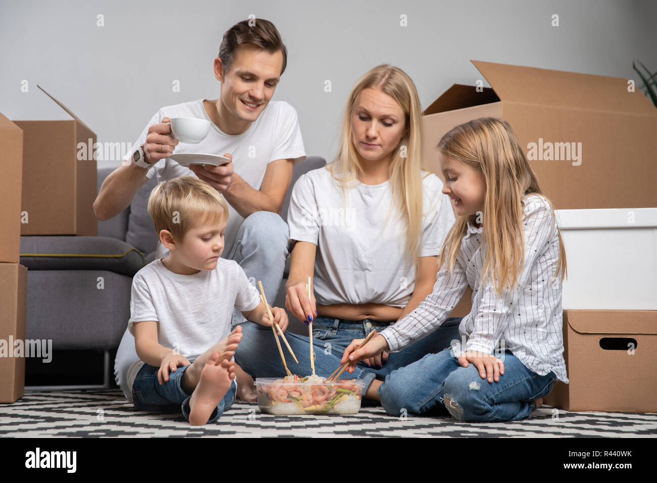 Image of parents with children eating rice with shrimps sitting on ...
