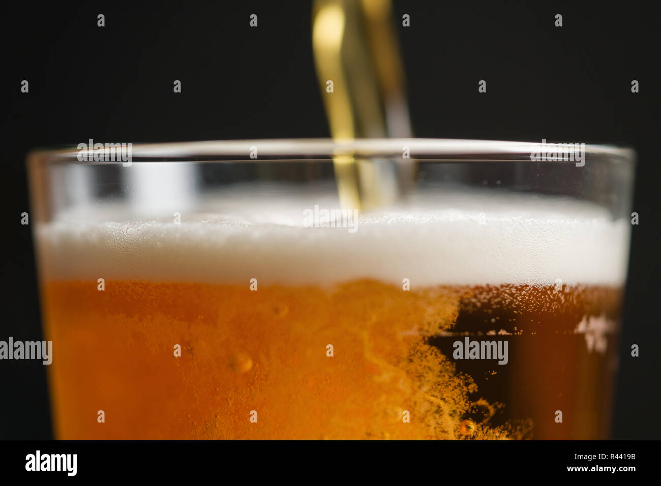 Closeup pouring beer in glass Stock Photo - Alamy