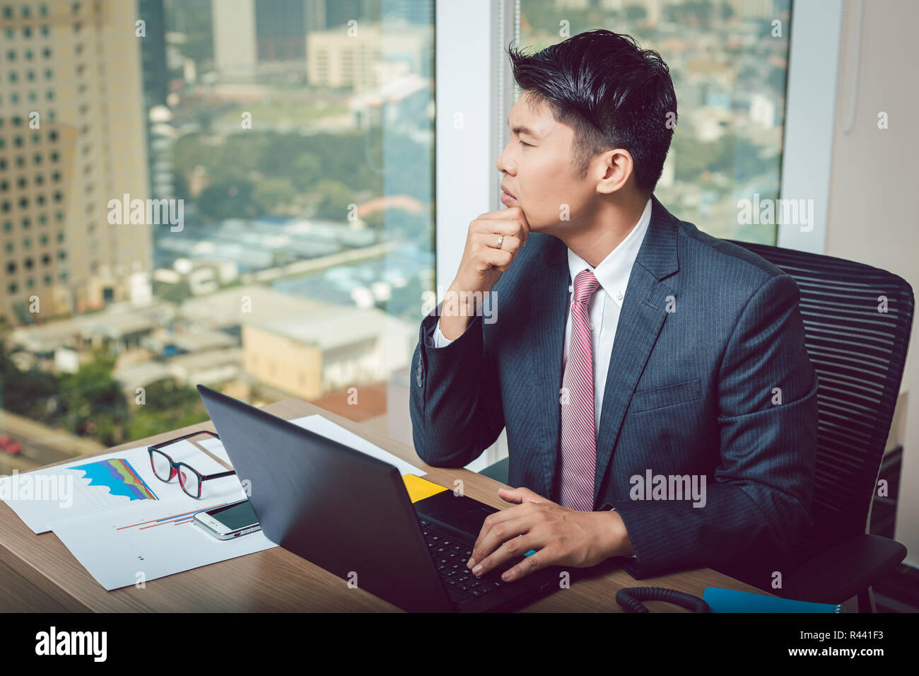 Thoughtful young business executive hi-res stock photography and images ...
