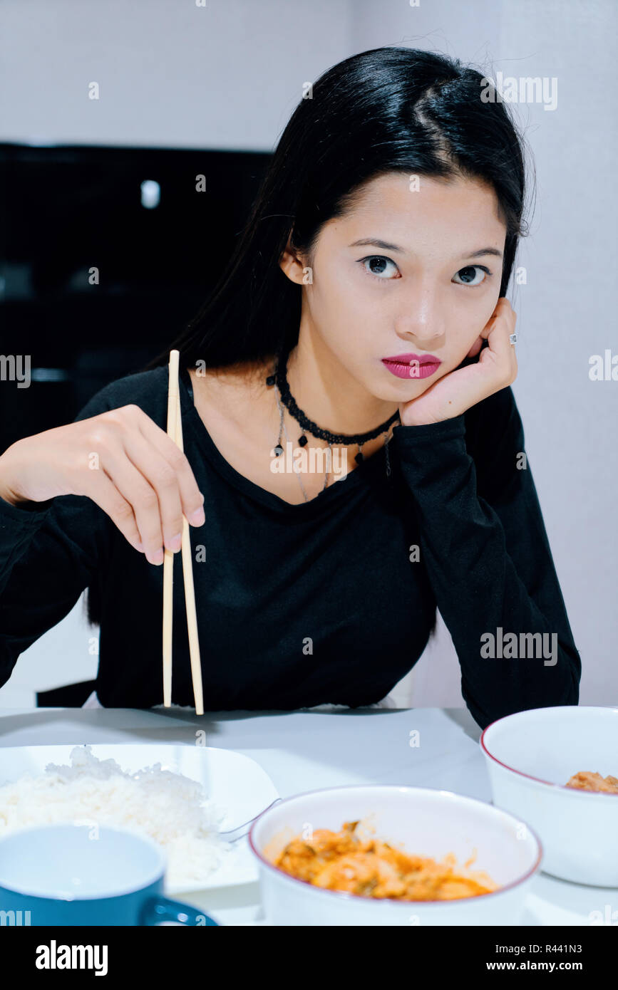 Beautiful woman posing - eating, sitting, sad, thinking Stock Photo - Alamy