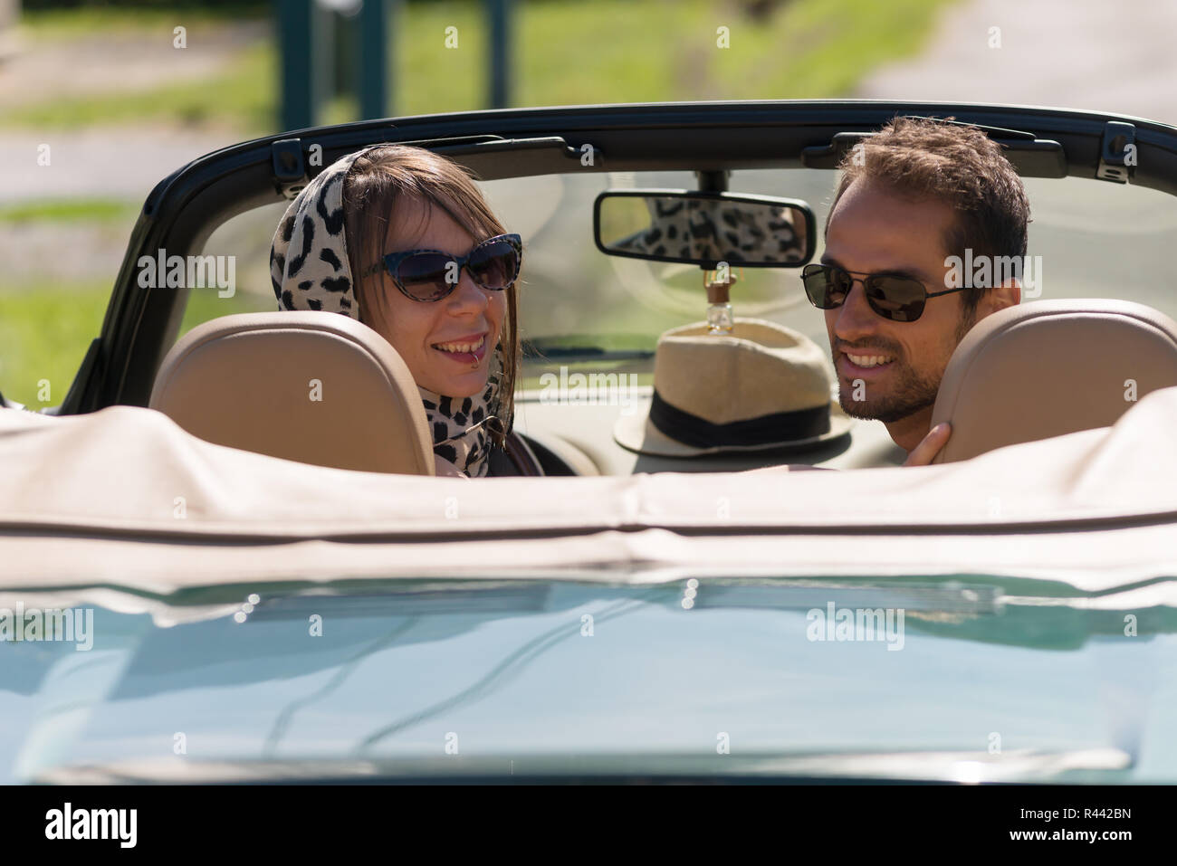 a young couple in a convertible car Stock Photo - Alamy