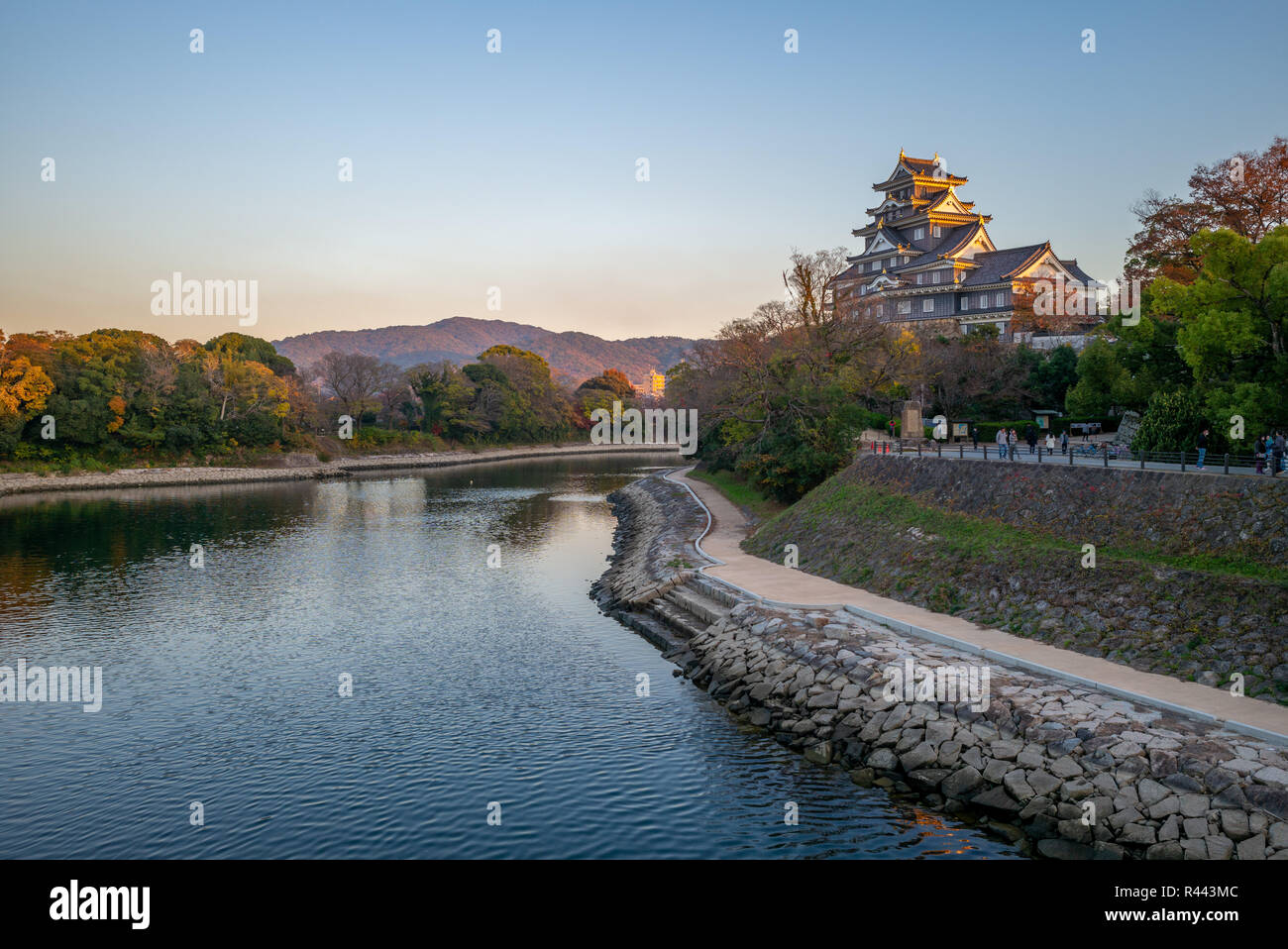 Okayama Castle by river asahi in japan at dusk Stock Photo - Alamy