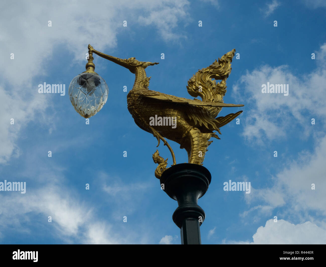 sculpture of golden swarn light pole and blue sky Stock Photo - Alamy