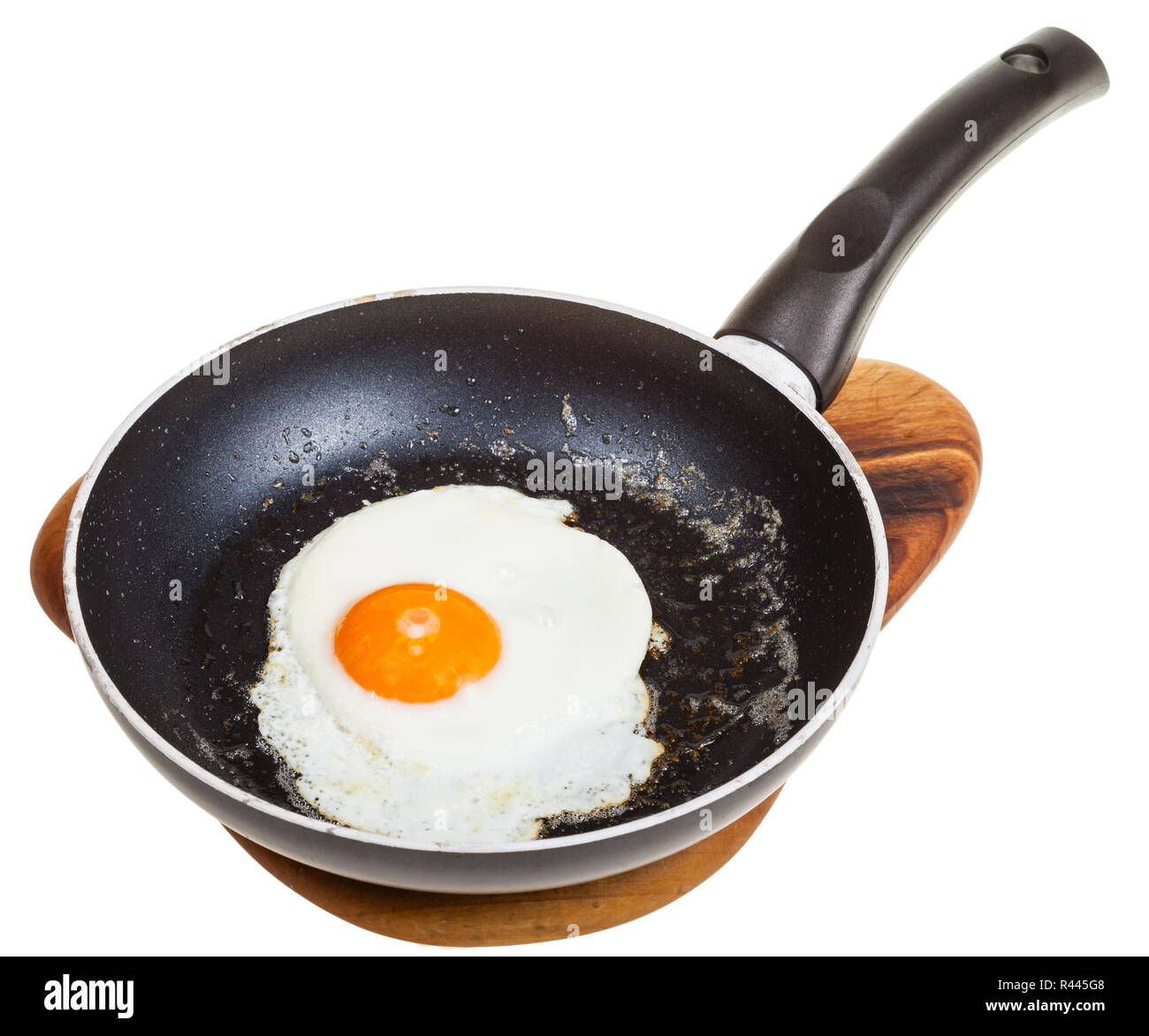 one fried egg in black frying pan isolated Stock Photo - Alamy
