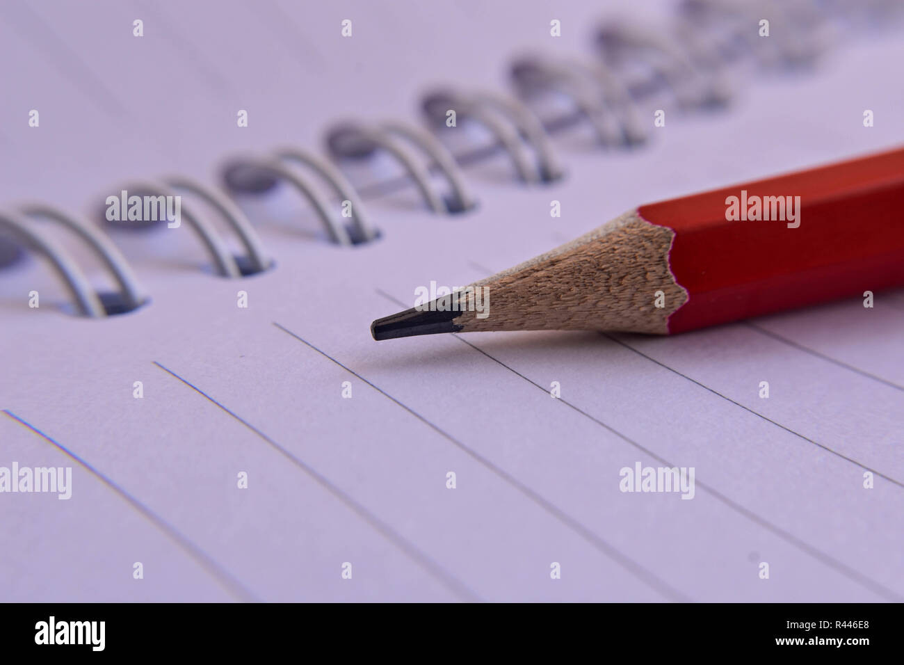 Red pencil with notebook on wooden table Save creative ideas on paper ...