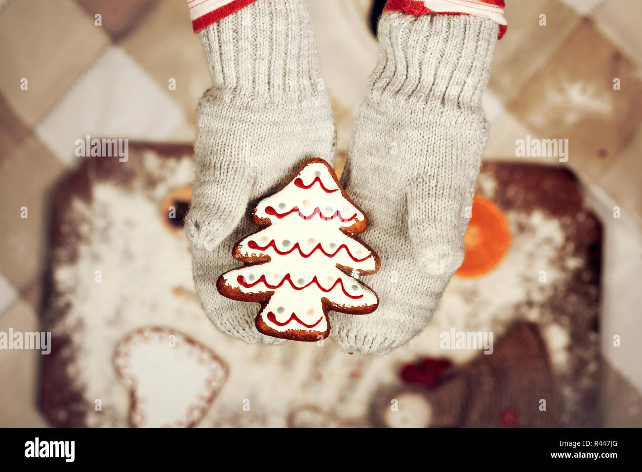 Child's hands in gloves holding gingerbread cookie Stock Photo - Alamy