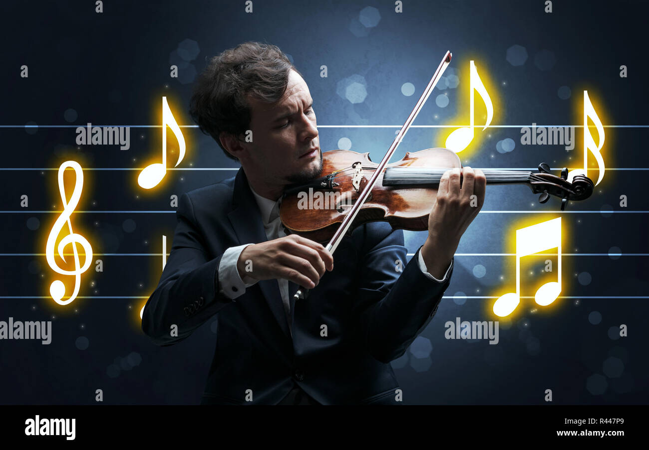 Young handsome fiddler playing with music sheet background Stock Photo ...