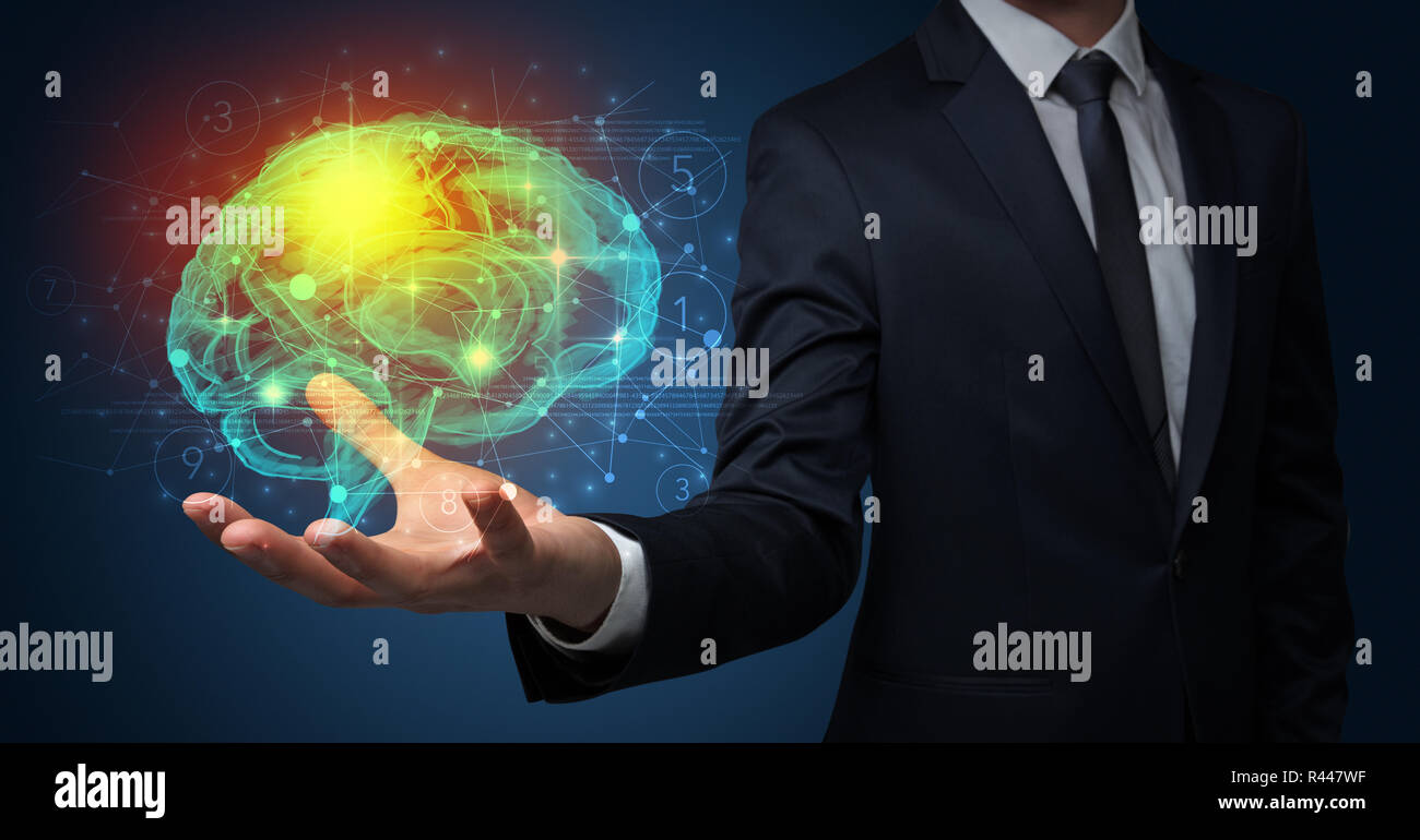 Businessman holding human brain on his hand with logistics symbols ...