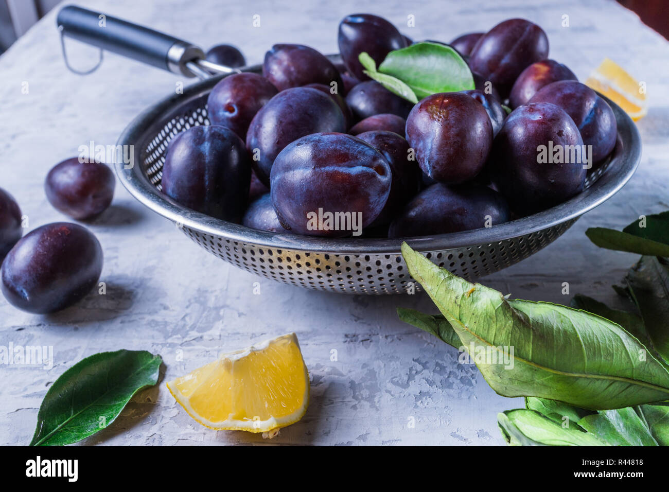 Flat lay view of ripe plums, on old wooden white background Stock Photo ...