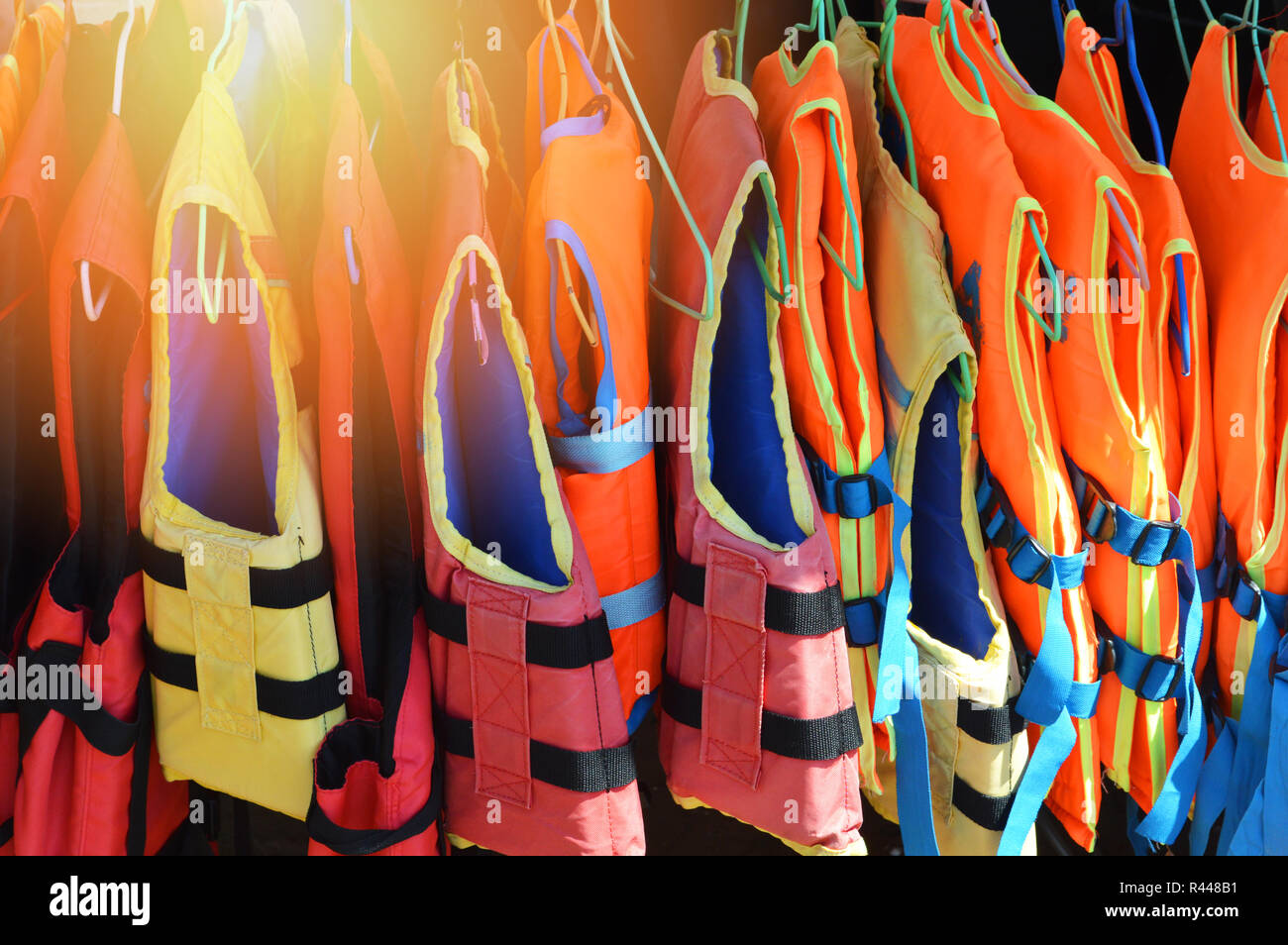 life jackets on clothes hanger / colorful of life jackets safety ...