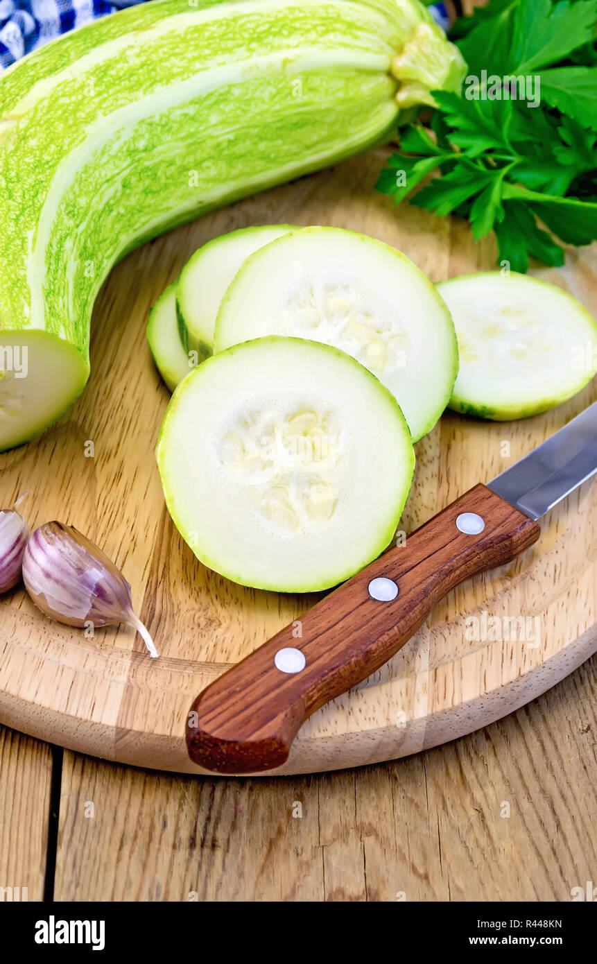 Zucchini green with knife on board Stock Photo - Alamy