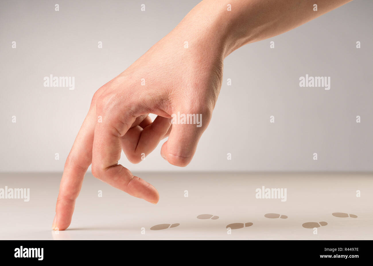 Female fingers walking on white surface with footsteps behind it Stock ...