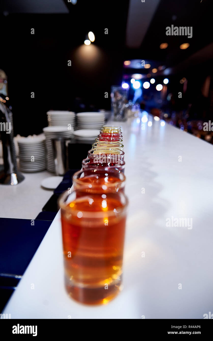 A row of colorful alcoholic shots at the bar Stock Photo - Alamy