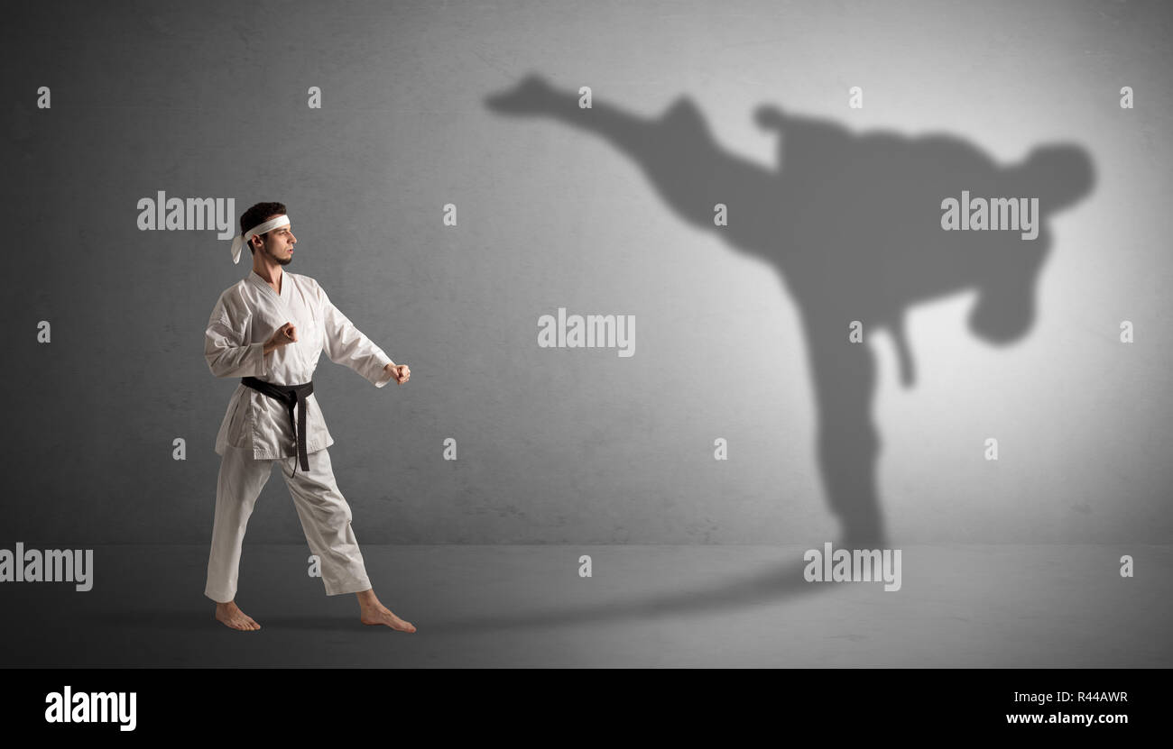 Young karate man confronting with his own shadow Stock Photo - Alamy