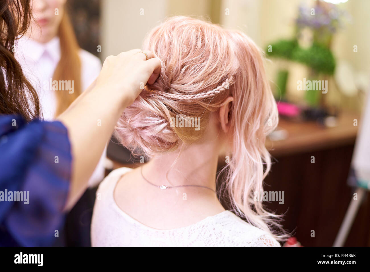 Hairdressing services.Сreating an evening hairstyle. Hair styling ...