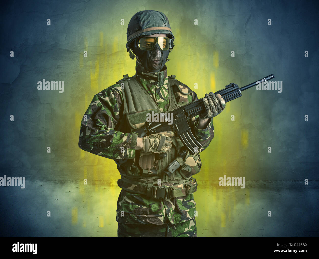 Hazard, menace soldier in a ruined crumbly building with arms on his ...