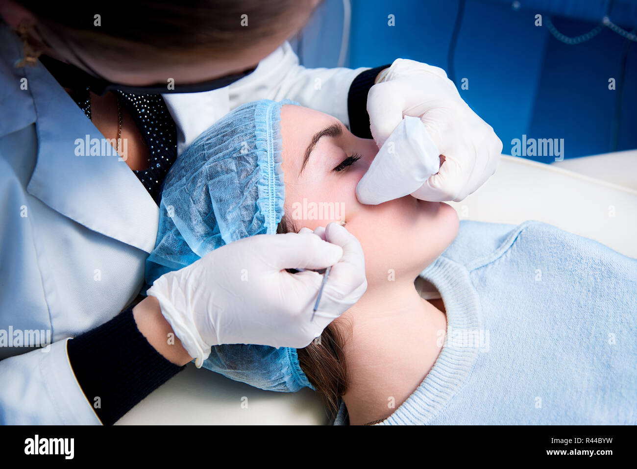 Cosmetic procedures.Cosmetologist at spa beauty salon doing acne ...