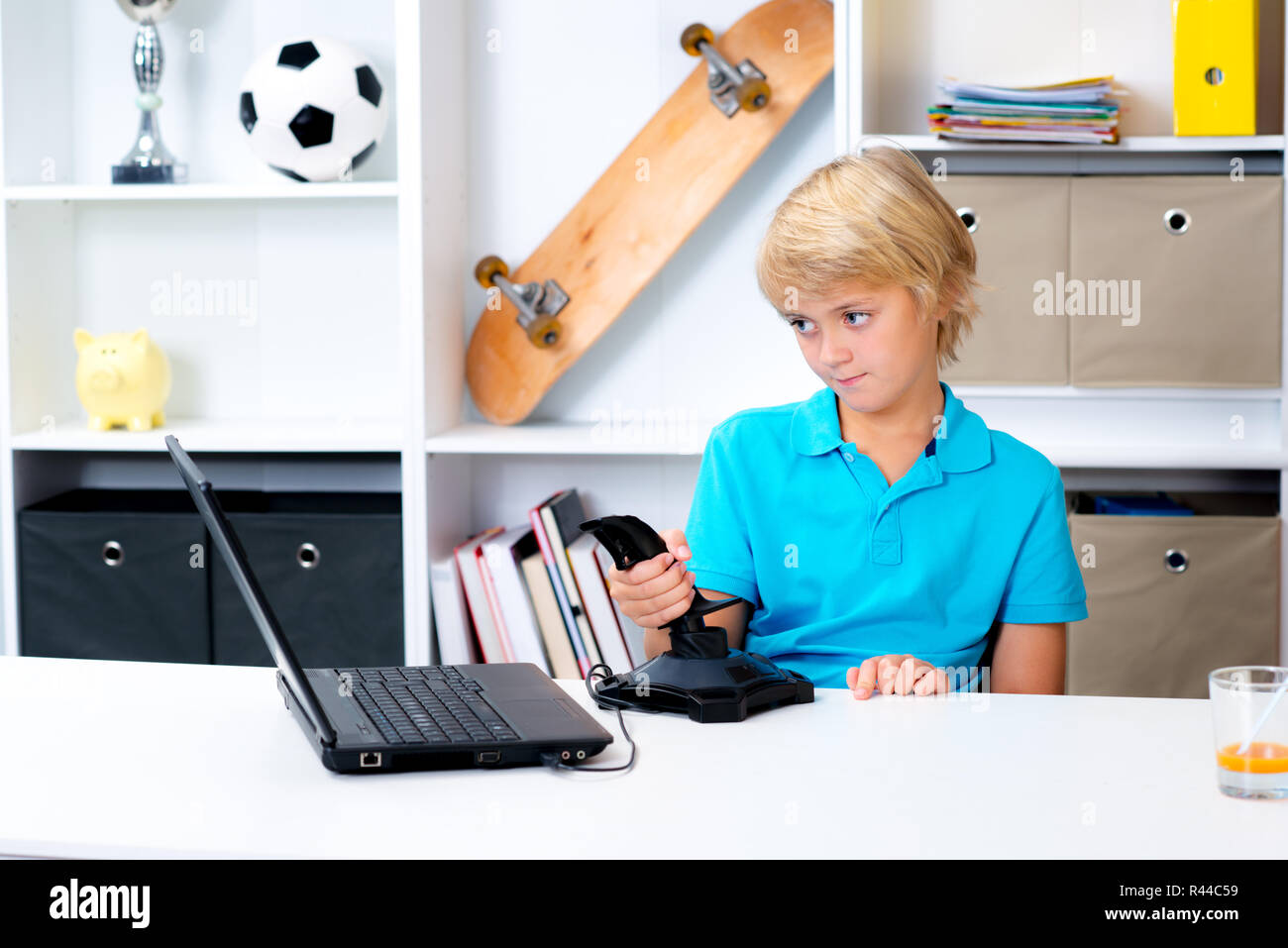 boy is playing computer game Stock Photo - Alamy