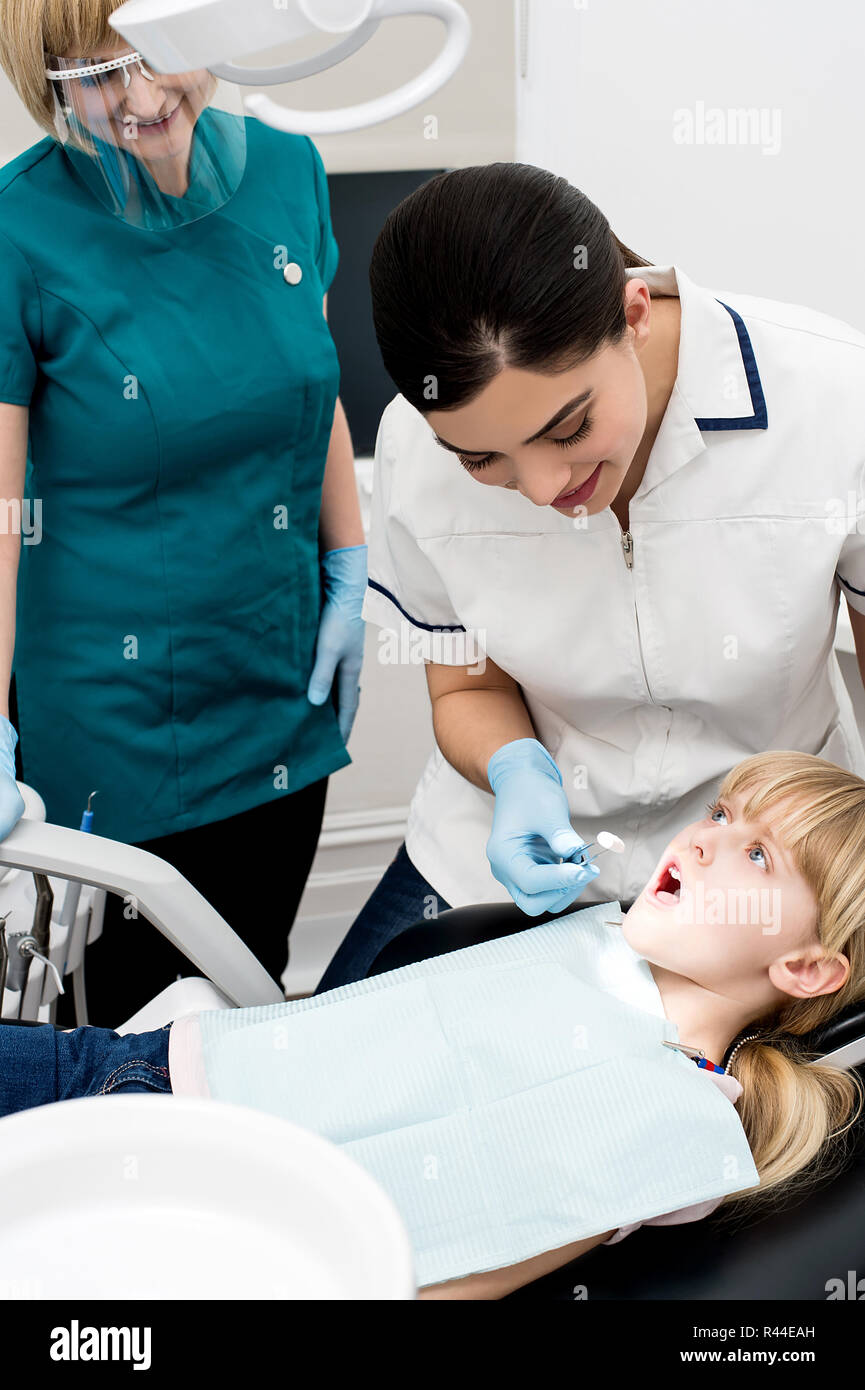Female doctor treating girl child Stock Photo - Alamy