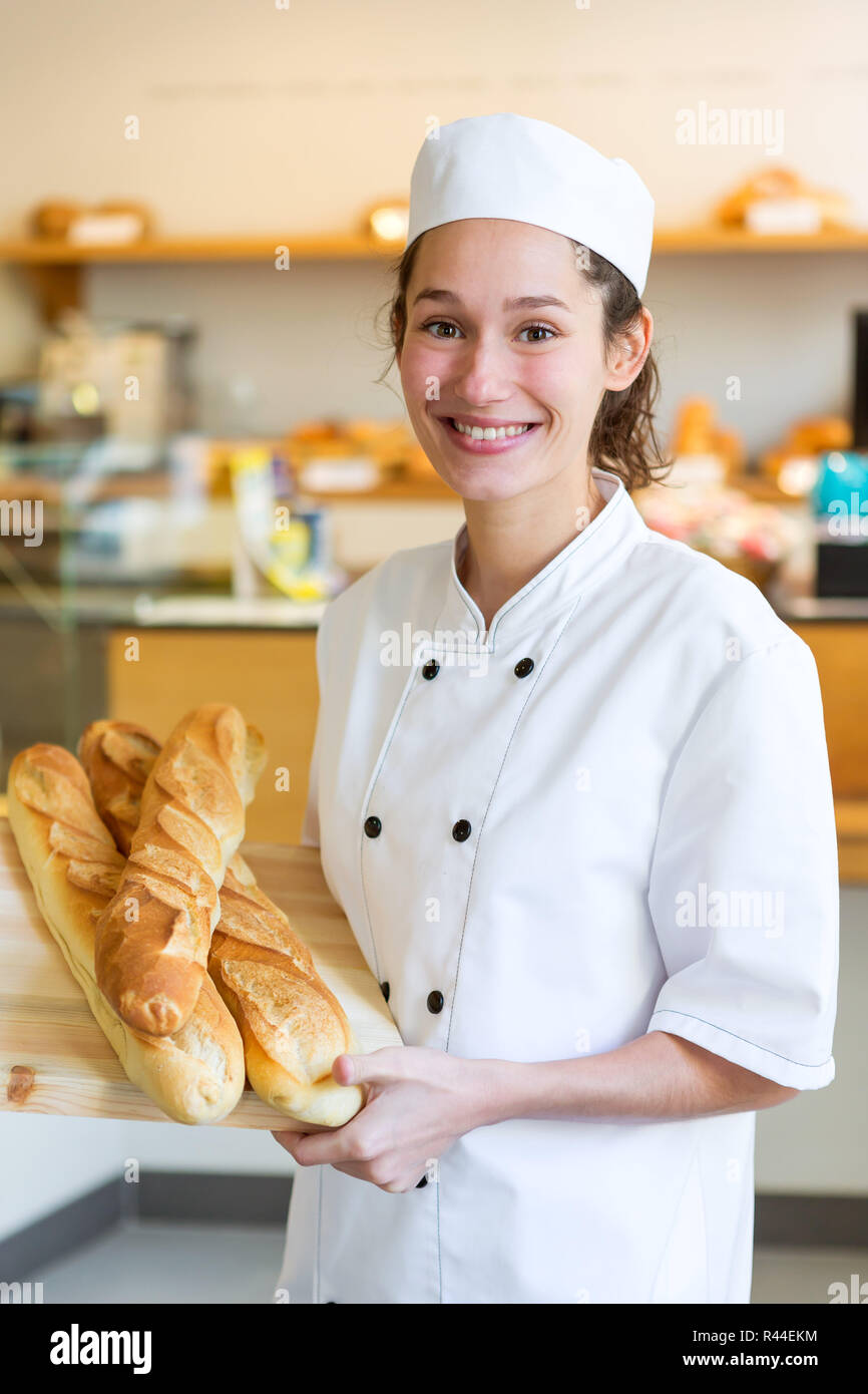 Young attarctive baker working at the bakery Stock Photo - Alamy