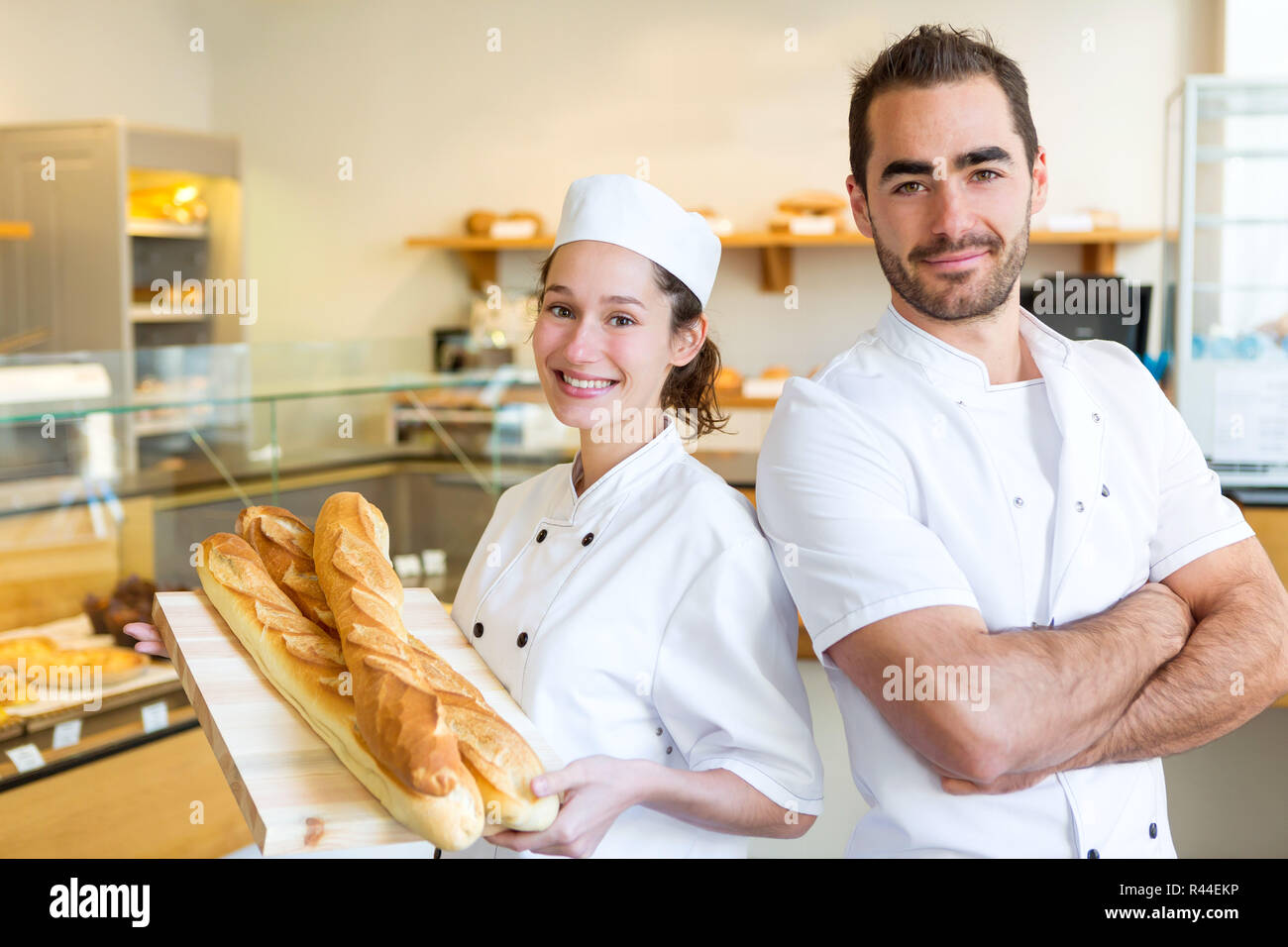 Team of bakers working at the bakery Stock Photo - Alamy