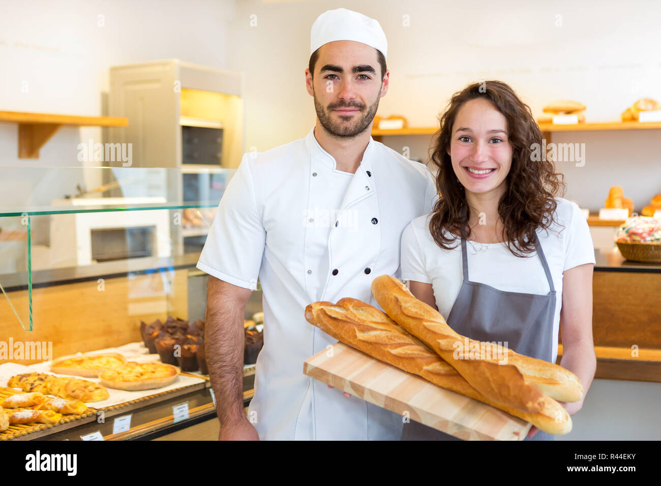 Team of bakers working at the bakery Stock Photo - Alamy