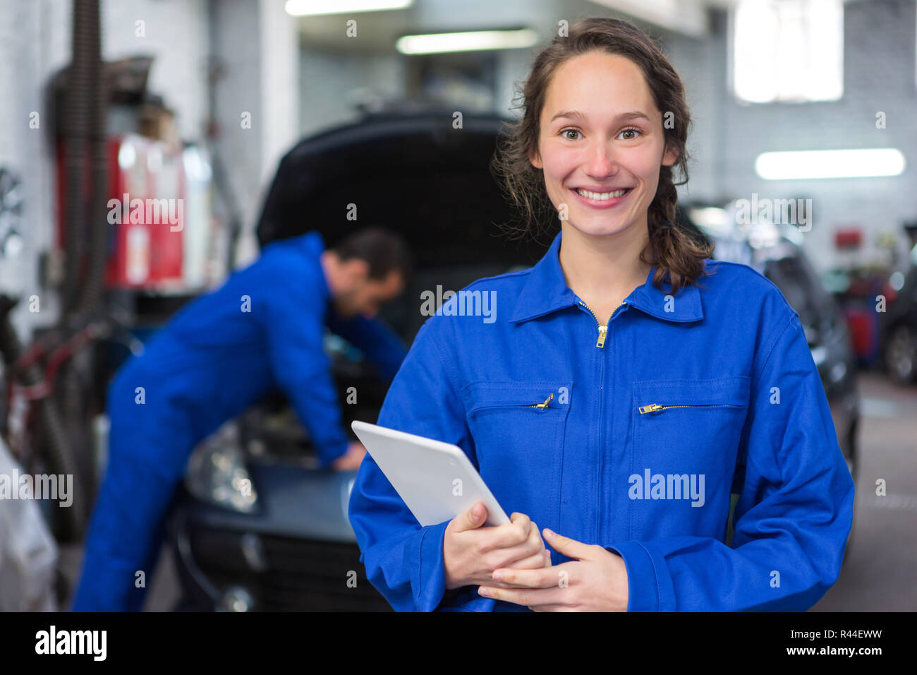 Young attractive woman mechanic working at the garage Stock Photo - Alamy