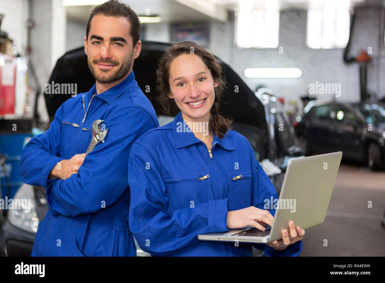 Team of mechanics working at the garage Stock Photo - Alamy