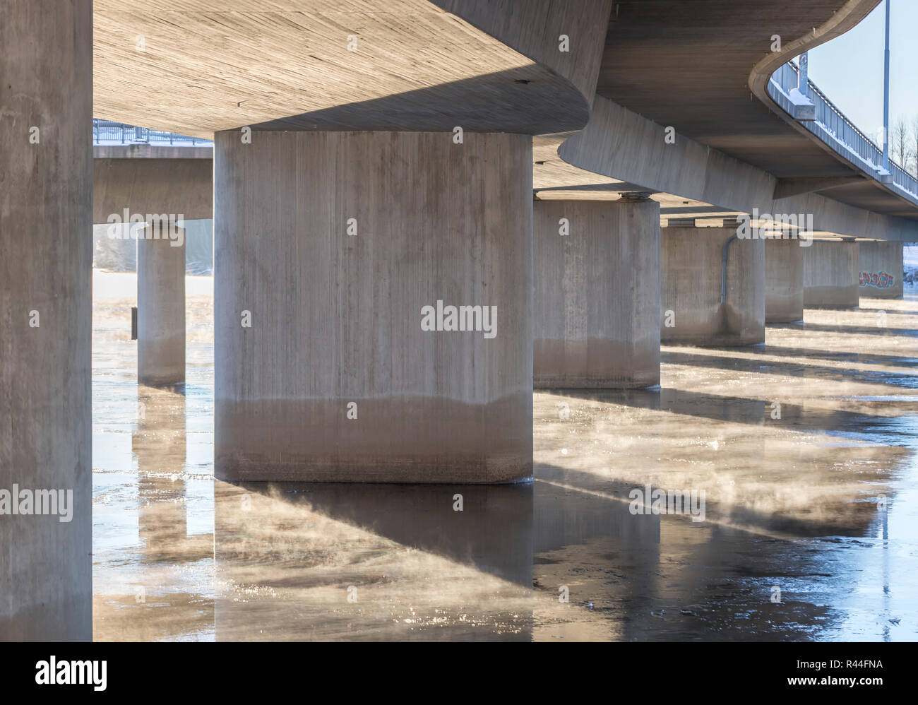 Mist on Icy River under Bridge Stock Photo - Alamy