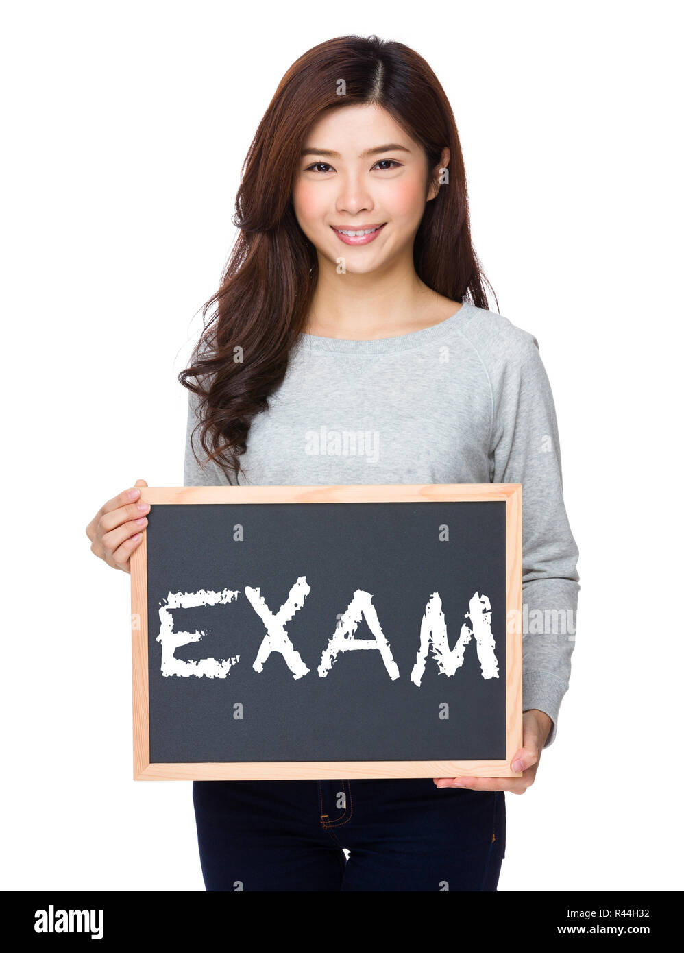 School girl hold with chalkboard and showing a word exam Stock Photo ...