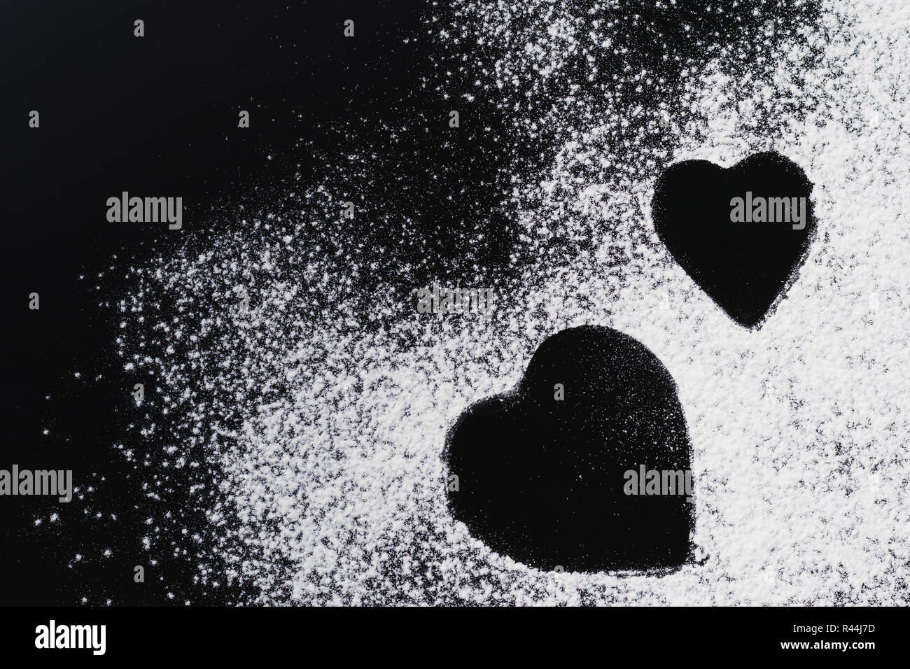 Baking background with heart shape and flour on dark table with copy ...