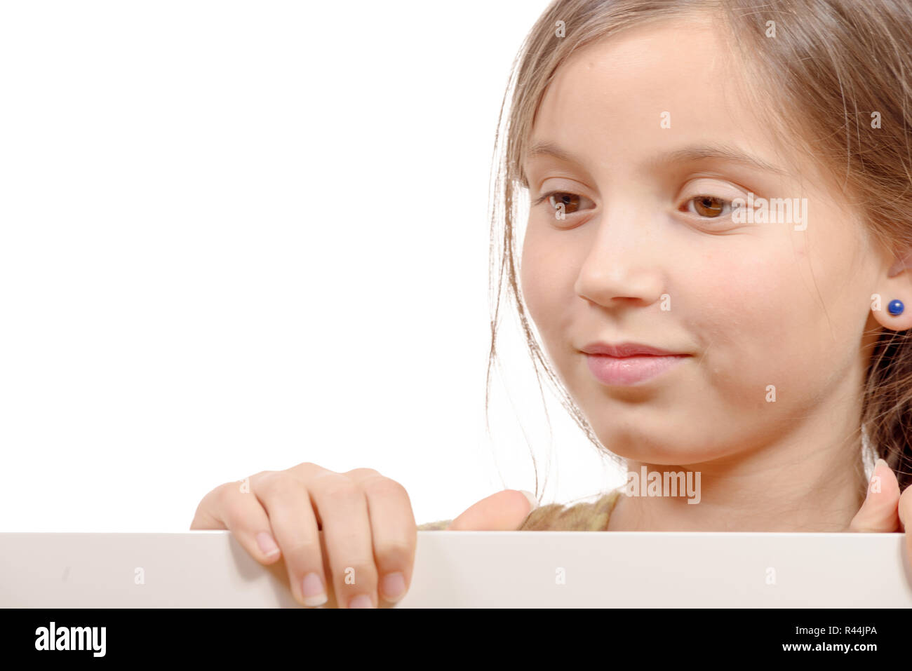 Beautiful young girl with a blank poster isolated on white background ...