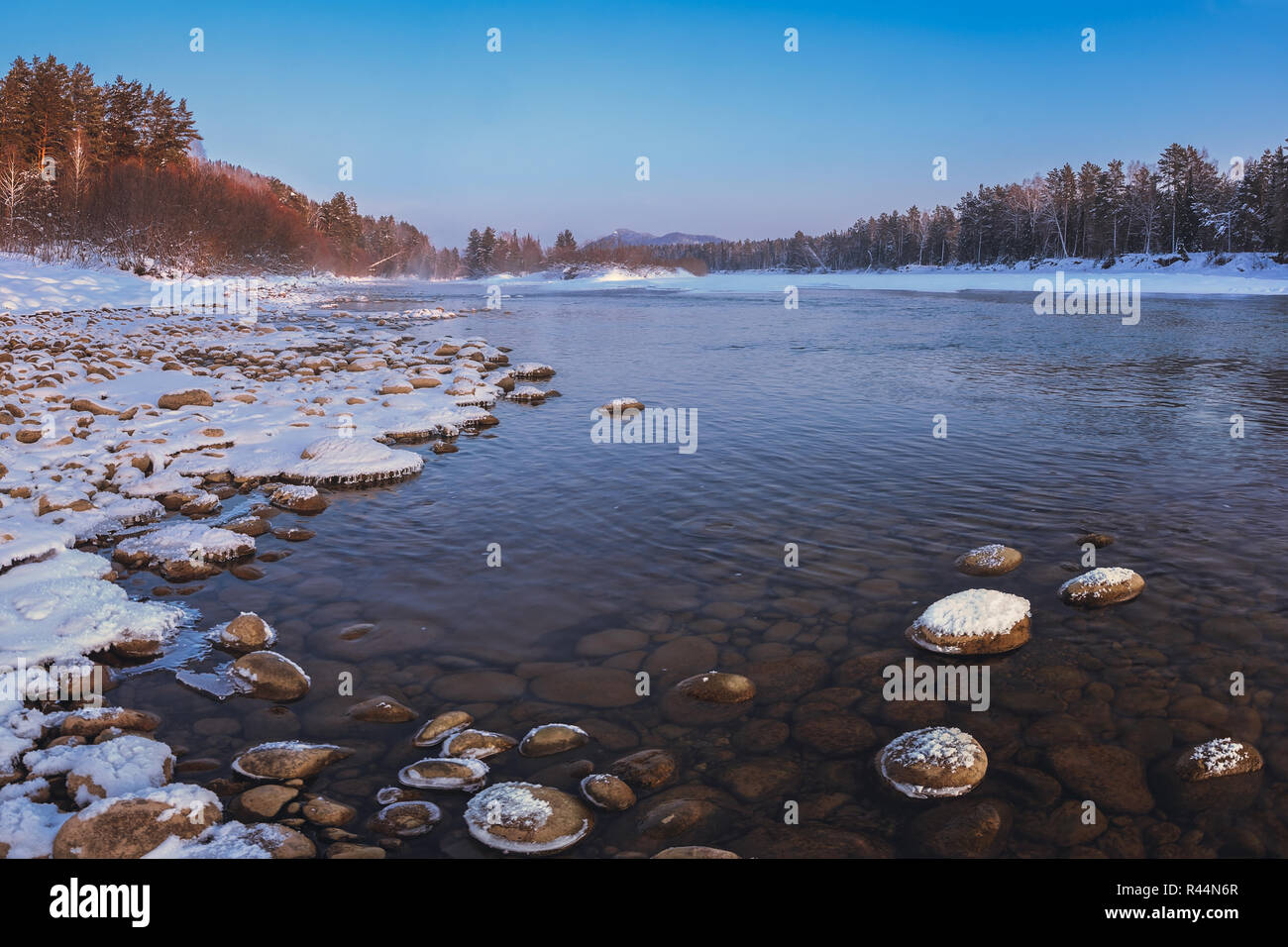 ALTAI, RUSSIA - JANUARY, 2016. Dawn over the Swan river, near the ...