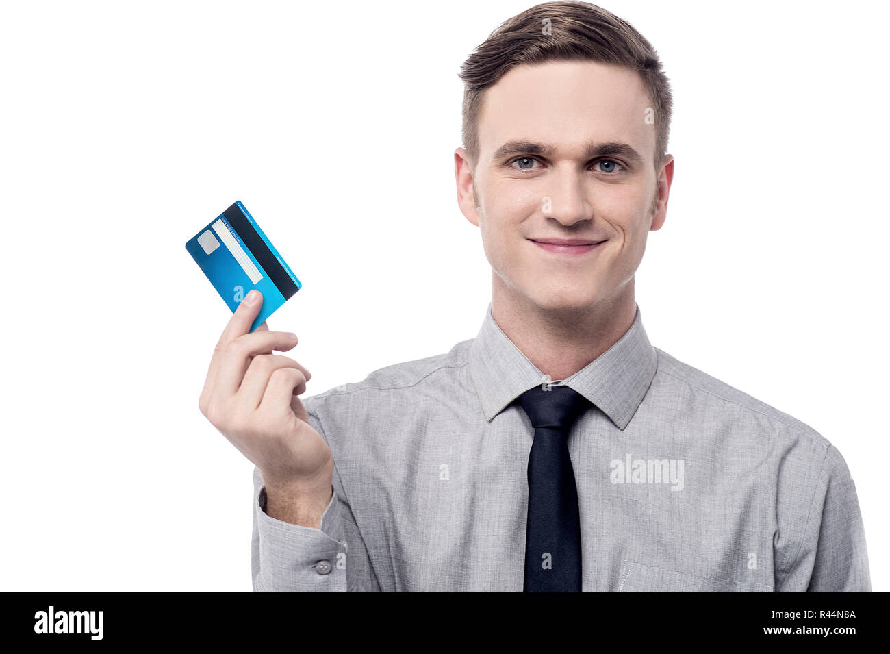 Handsome salesman showing credit card Stock Photo - Alamy