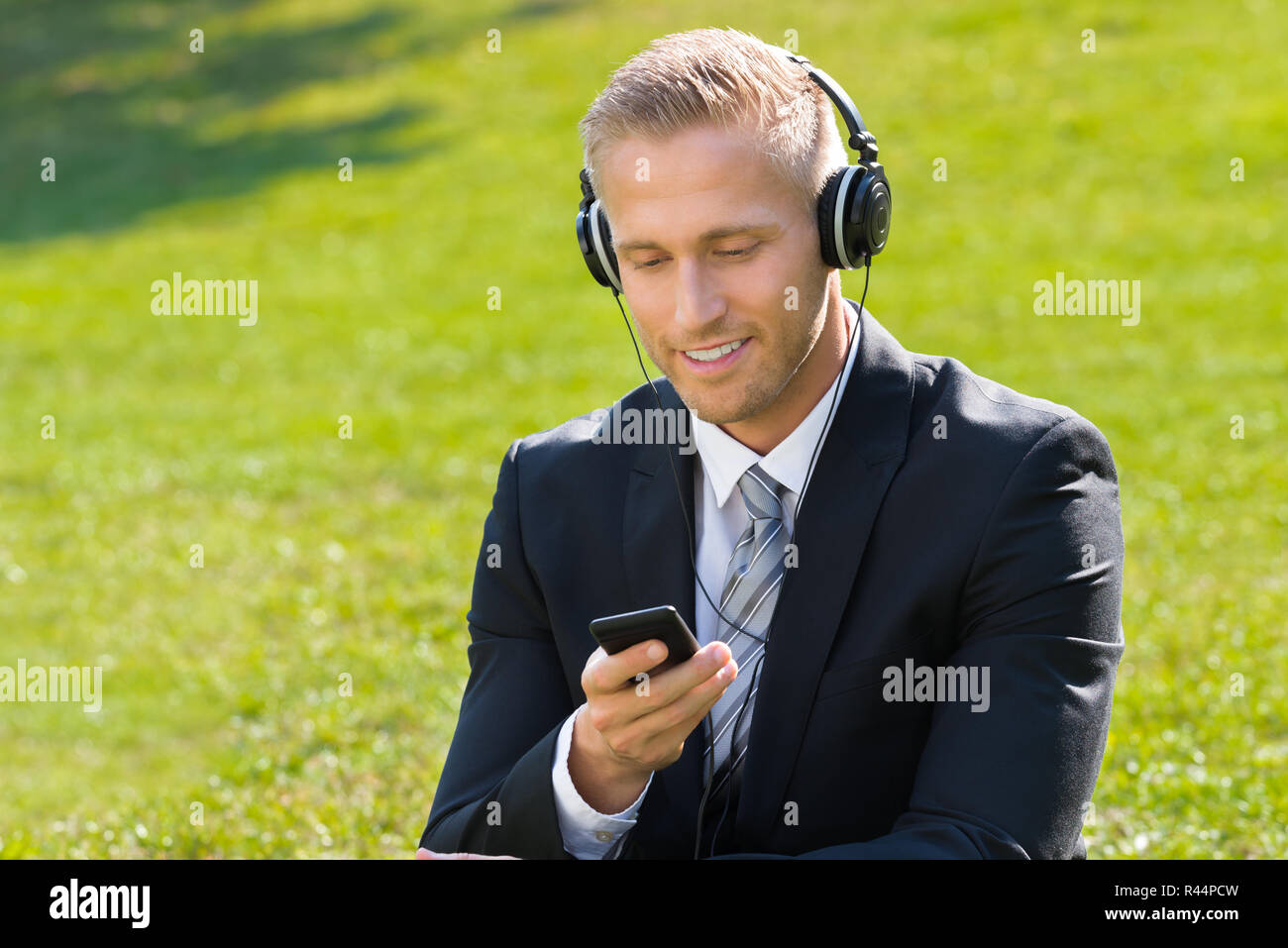Attentive smiling businessman listening hi-res stock photography and ...