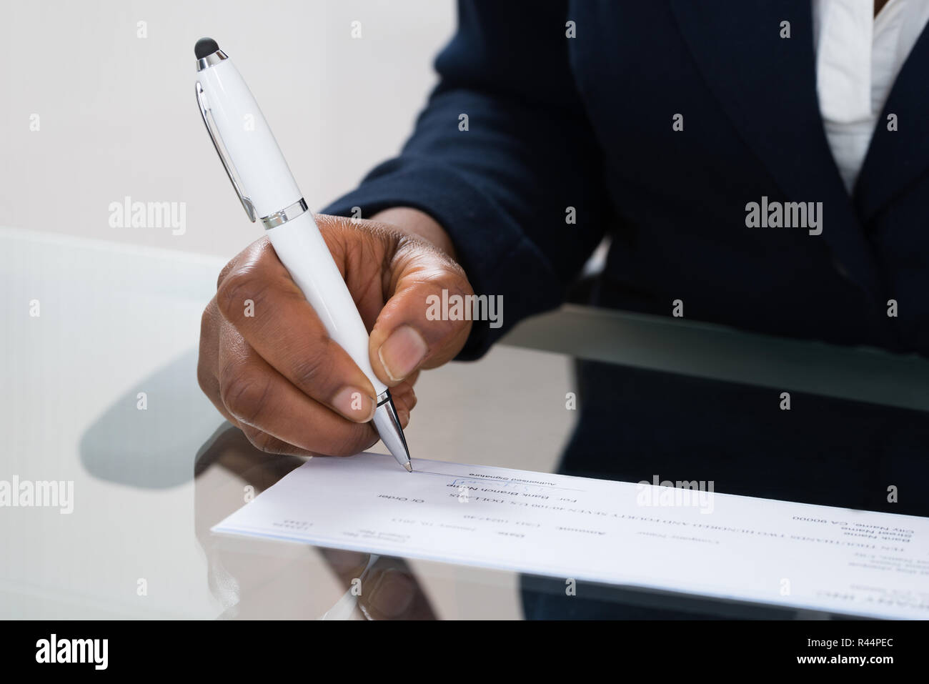 Person's Hand Signing Cheque Stock Photo - Alamy
