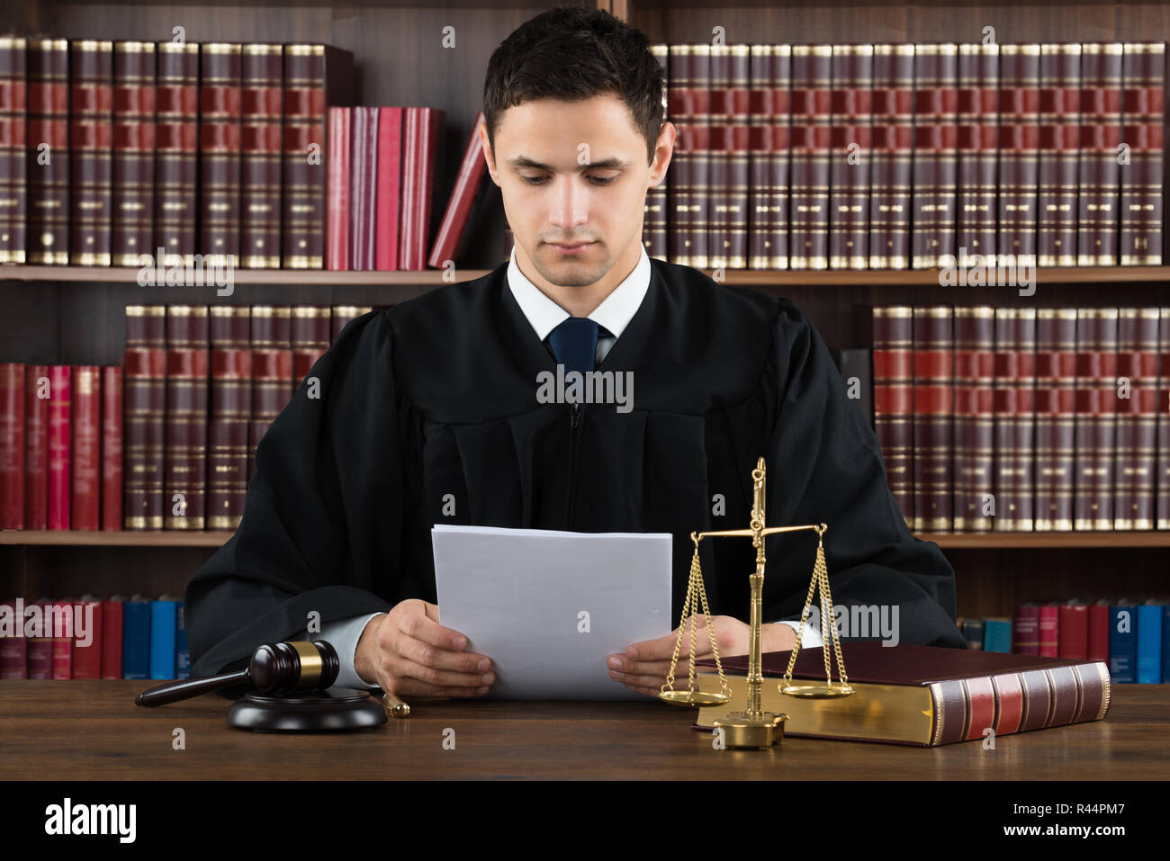 Judge Reading Documents At Desk In Courtroom Stock Photo - Alamy