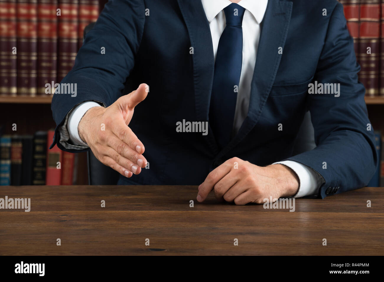 Lawyer Offering Handshake At Desk In Courtroom Stock Photo - Alamy