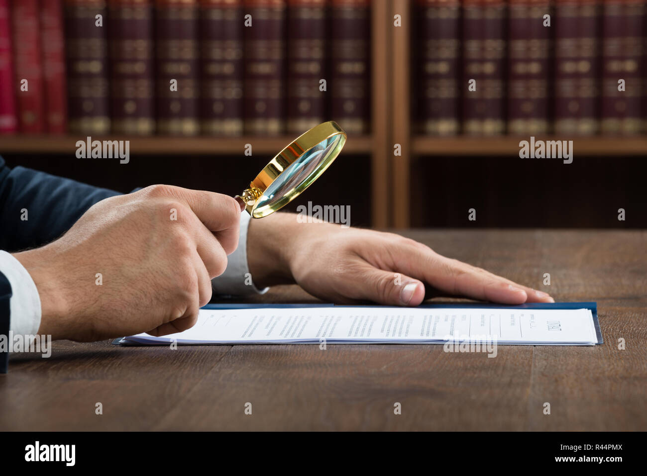 Lawyer Examining Documents With Magnifying Glass Stock Photo - Alamy