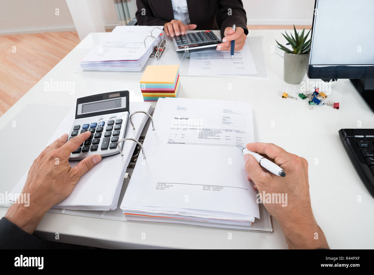 Two Businesspeople Calculating Financial Statement Stock Photo - Alamy