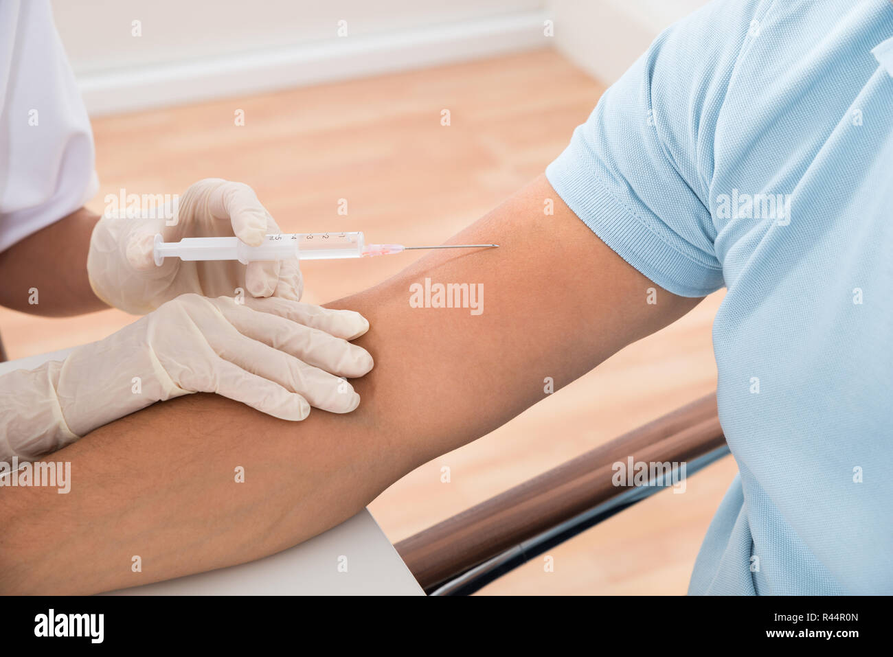 Doctor Injecting Patient With Syringe Stock Photo - Alamy