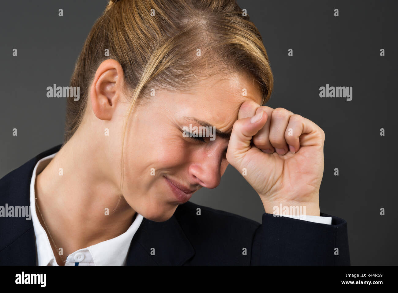 Depressed Businesswoman Banging Hand On Head Stock Photo - Alamy