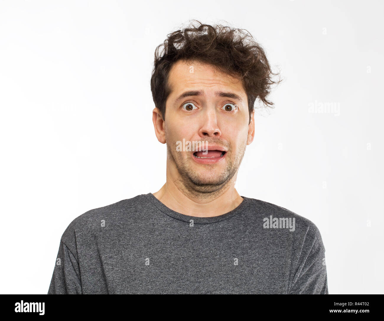 Portrait of frightened male on a white background Stock Photo - Alamy