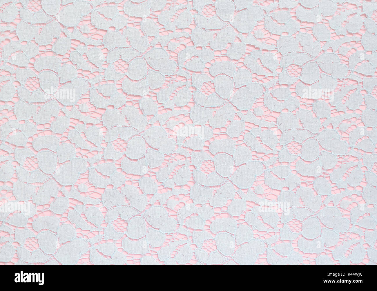 Light-blue lace texture on a pink background Stock Photo - Alamy