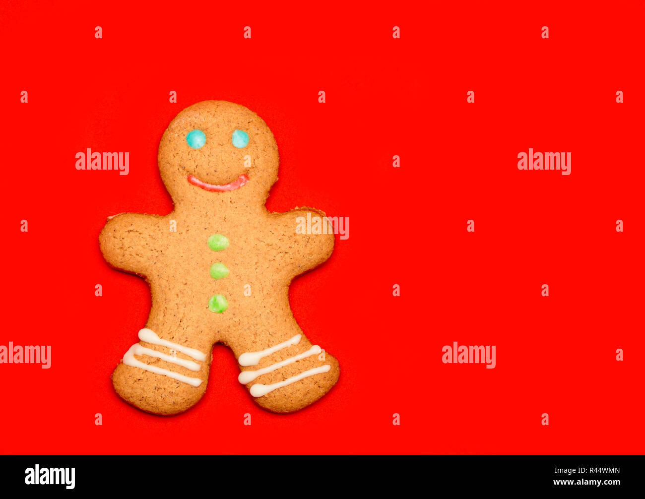 Iced Christmas Gingerbread man sugar cookie on red background Stock ...