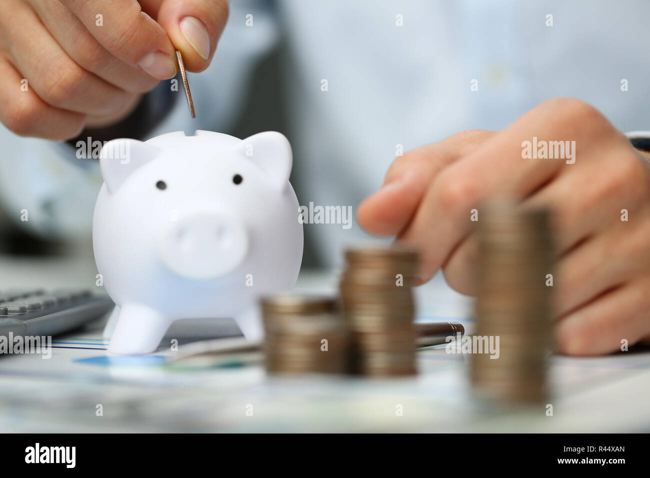 Hand businessman putting pin money Stock Photo - Alamy