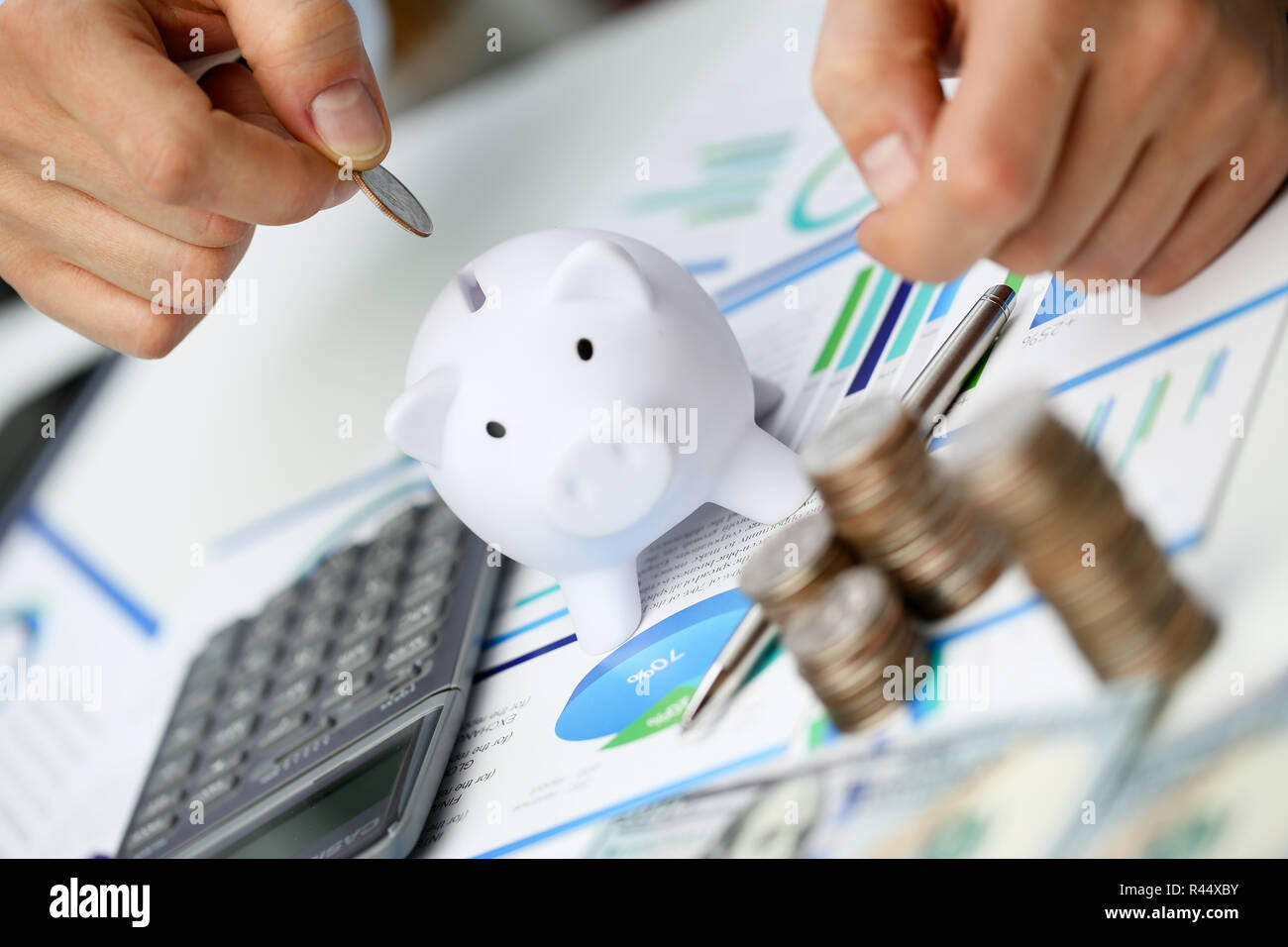 Hand businessman putting pin money Stock Photo - Alamy