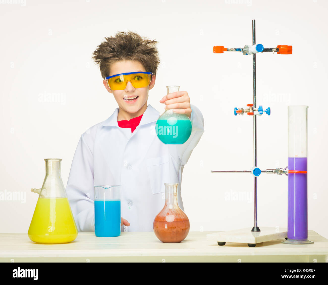 Little boy as chemist doing experiment with chemical fluid Stock Photo ...