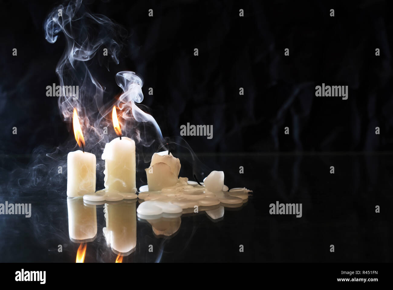 Set of extinguished candles with fire and smoke on nice dark background ...